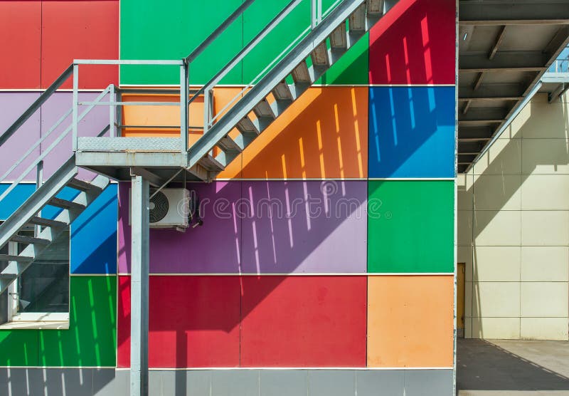 Metal Fire Escape or Emergency Exit on Multicolored Wall of Building ...