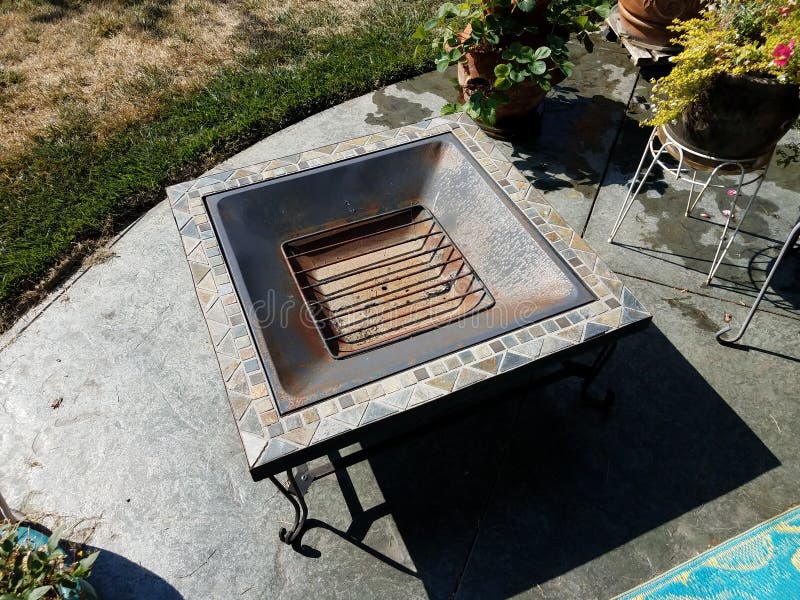 Metal Fire Pit or Grill on Cement Slab Stock Photo - Image of outdoor ...