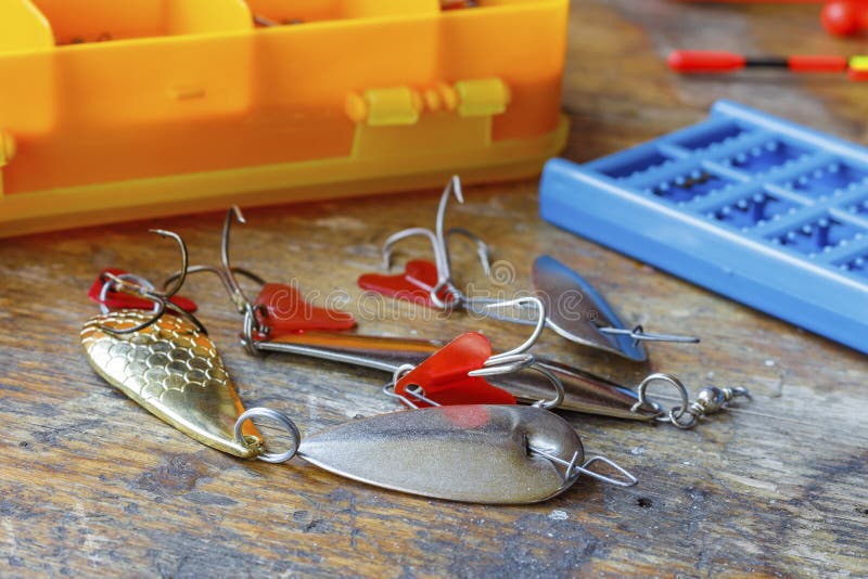 Metal Fishing Baits with Accessories on a Wooden Table Stock Photo ...