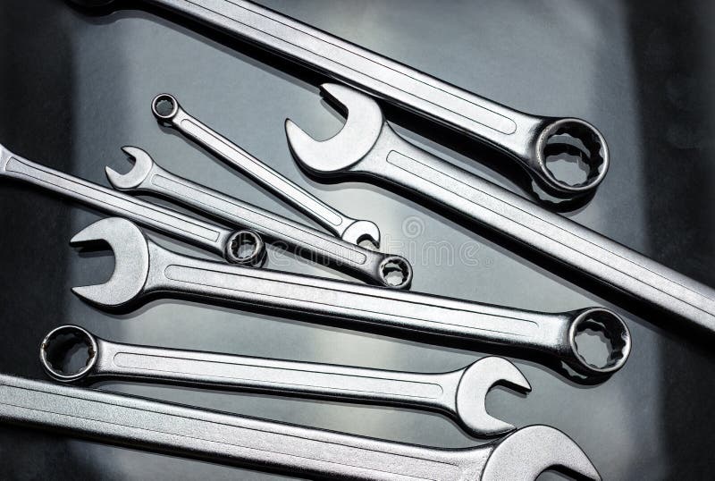 Metal Flat Wrenches Lying on a Black, Shiny Table, Flat View from Above ...
