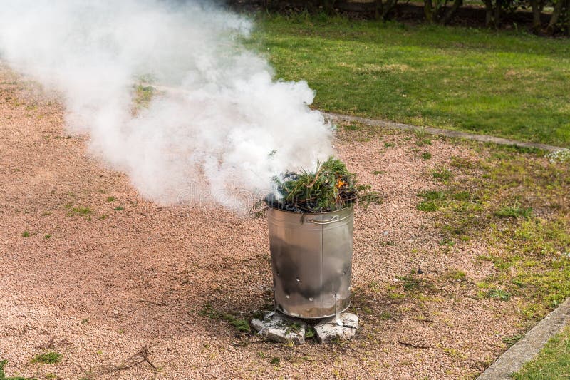 Metal Garden Incinerator with the Branches of the Plants that Burning ...