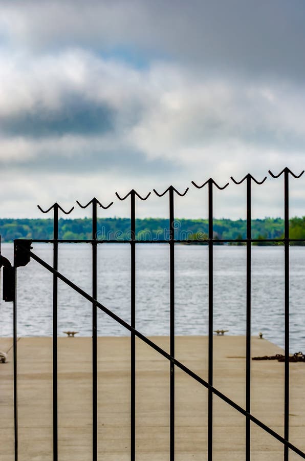 Metal Gate with Finials in Overlooking a Dock and the St. Lawrence ...