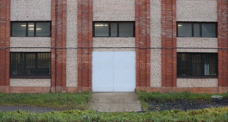 Metal Gates in the Brick Wall of an Industrial Building Stock Photo ...