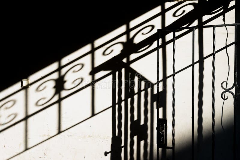 Metal Gates with Shadow on Wall Stock Photo - Image of entrance, black ...