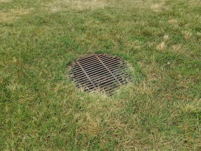 Metal Grate on Drain in the Grass Stock Photo - Image of grass ...