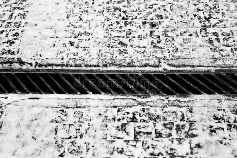 Metal Grid in Snow Covered Pavement Stock Image - Image of snow ...