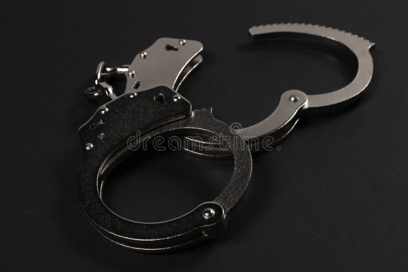 Metal Handcuffs on a Dark Surface Close Up Stock Image - Image of crime ...