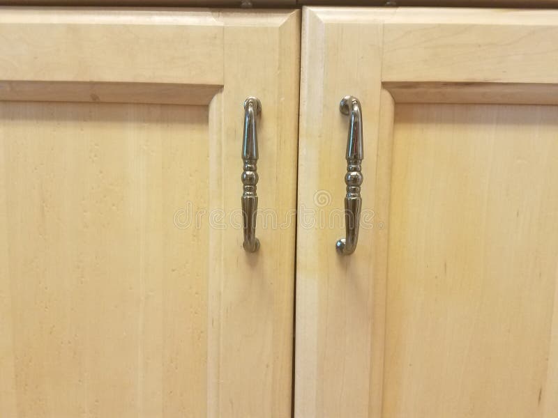 Metal Handle on Brown Kitchen Cabinet Stock Image - Image of metallic ...