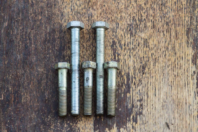 Metal Hardware with Carvings Figures on a Wooden Background Stock Photo ...
