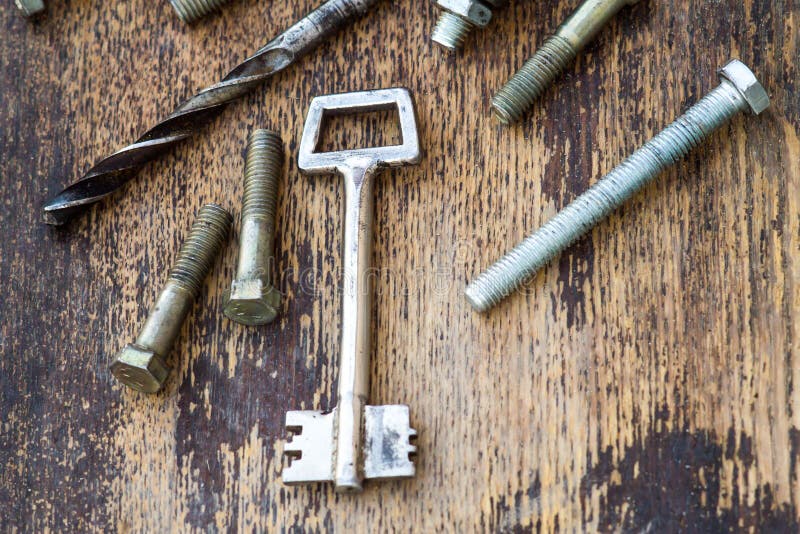 Metal Hardware with Carvings Figures on a Wooden Background Stock Photo ...
