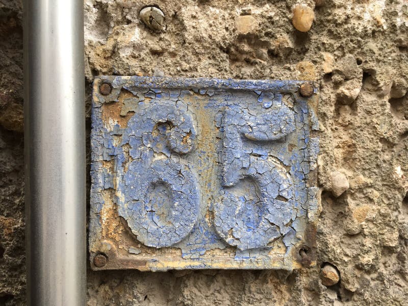 65 on metal house plate stock photo. Image of wall, peeling - 85928940