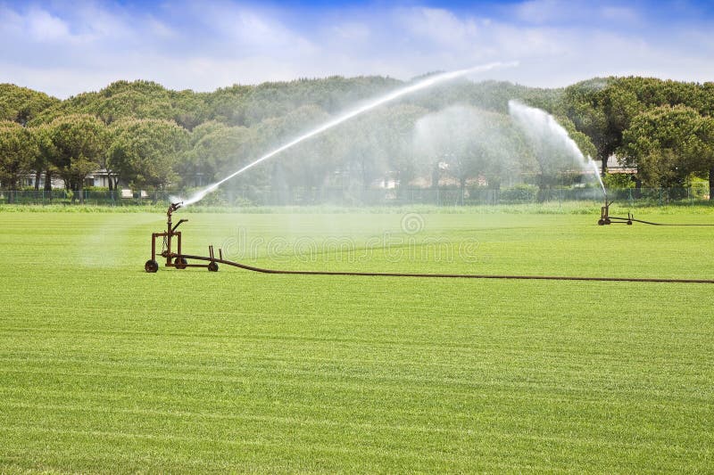 Metal Irrigator in a Green Mowed Lawn Stock Image - Image of ...