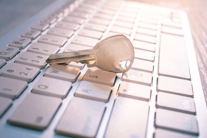 Metal Key on a White Keyboard - Secure Computer Login Concept Stock ...