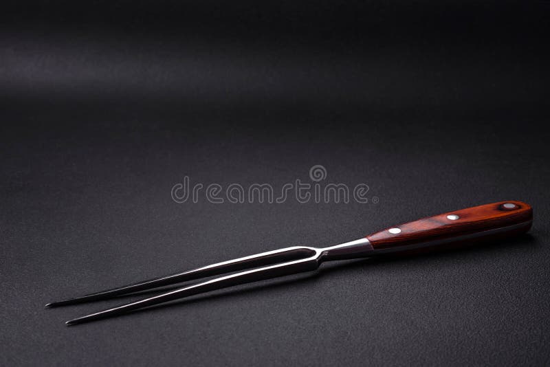 Metal Kitchen Fork on a Dark Textured Concrete Background Stock Image ...