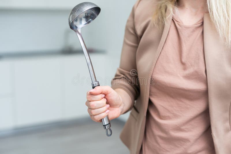 Metal Kitchen Ladle in Hand, Isolated on a White Background Stock Image ...