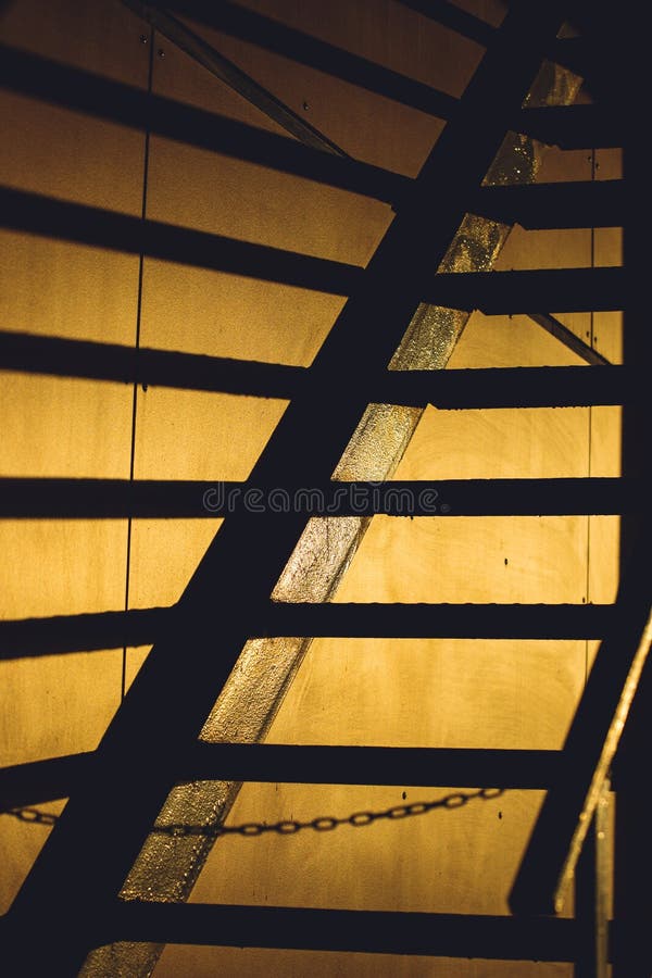 Metal Ladder Creates Long Black Shadow Lines on the Wall during Sunset ...