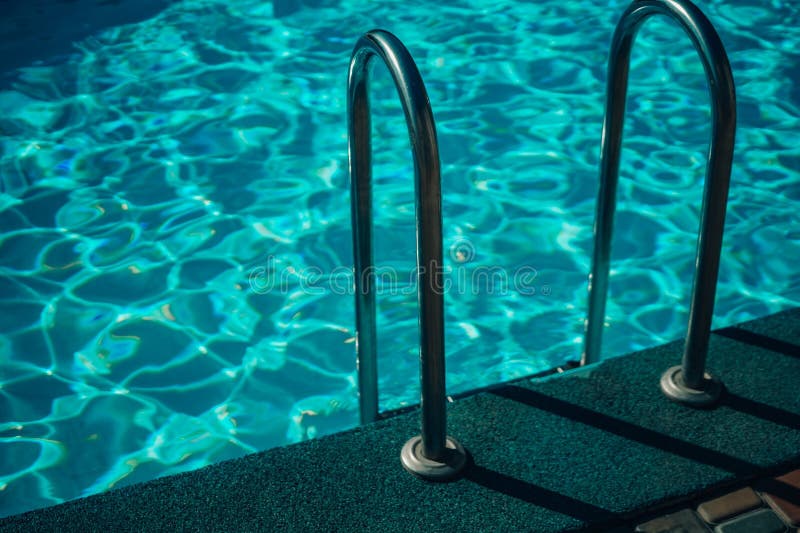 A Metal Ladder is in the Water. the Water is Clear and Calm. the Ladder ...