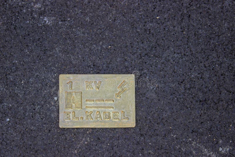 Metal Marker on the Asphalt - High Voltage Cables Below Stock Image ...
