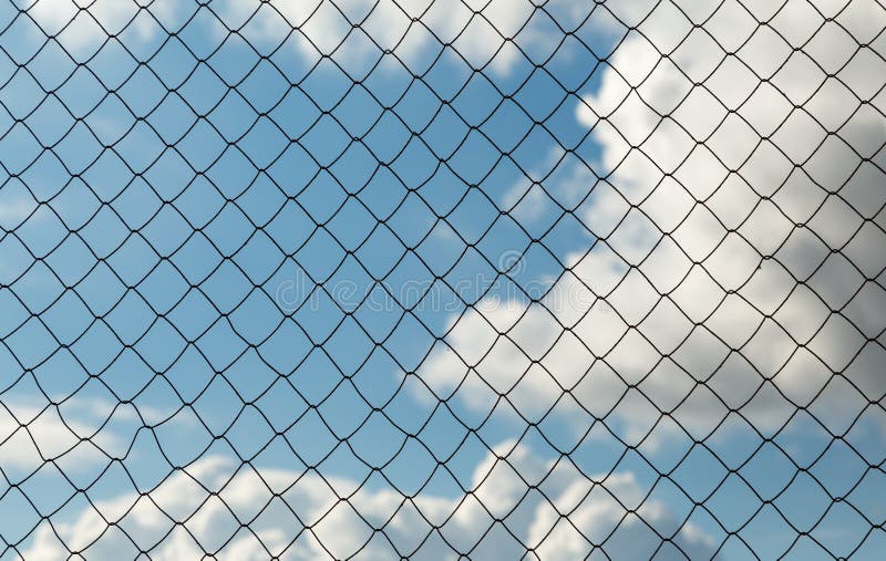 Metal Mesh Netting on the Blue Sky Background and Clouds Stock Photo ...