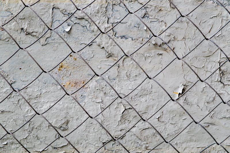 Metal Mesh Netting Over a Gray Wall with Cracked Paint Stock Image ...