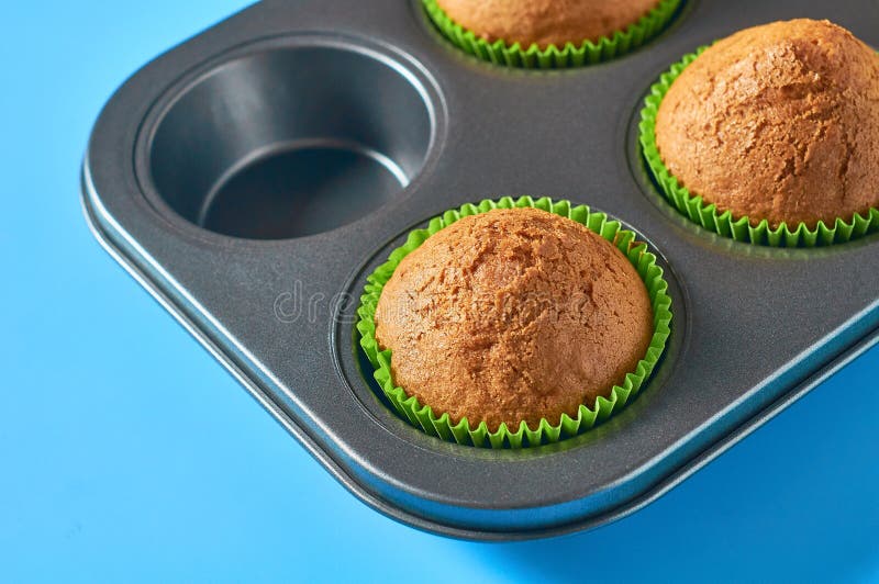 Metal Mold without One Fluffy Muffin on Blue Stock Photo - Image of ...