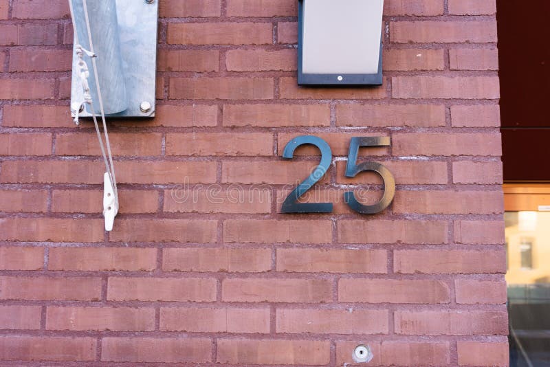 Metal Number Twenty-five Sign on a Red Brick Wall Stock Photo - Image ...