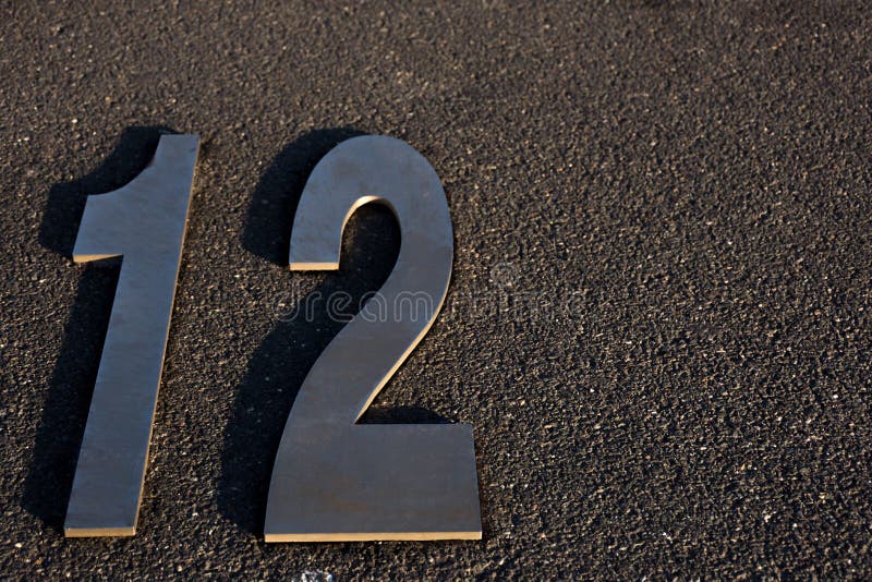 Metal Numbers in the Ground Stock Photo - Image of community, field ...