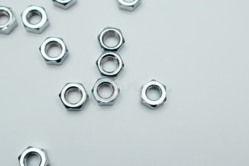 Metal Nuts Made of Stainless Steel. Hexagon Nuts Scattered on White ...