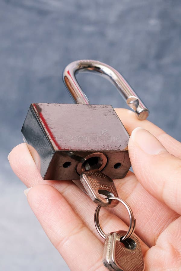 Metal Padlock and Keys in Hand on Gray Background Stock Photo - Image ...