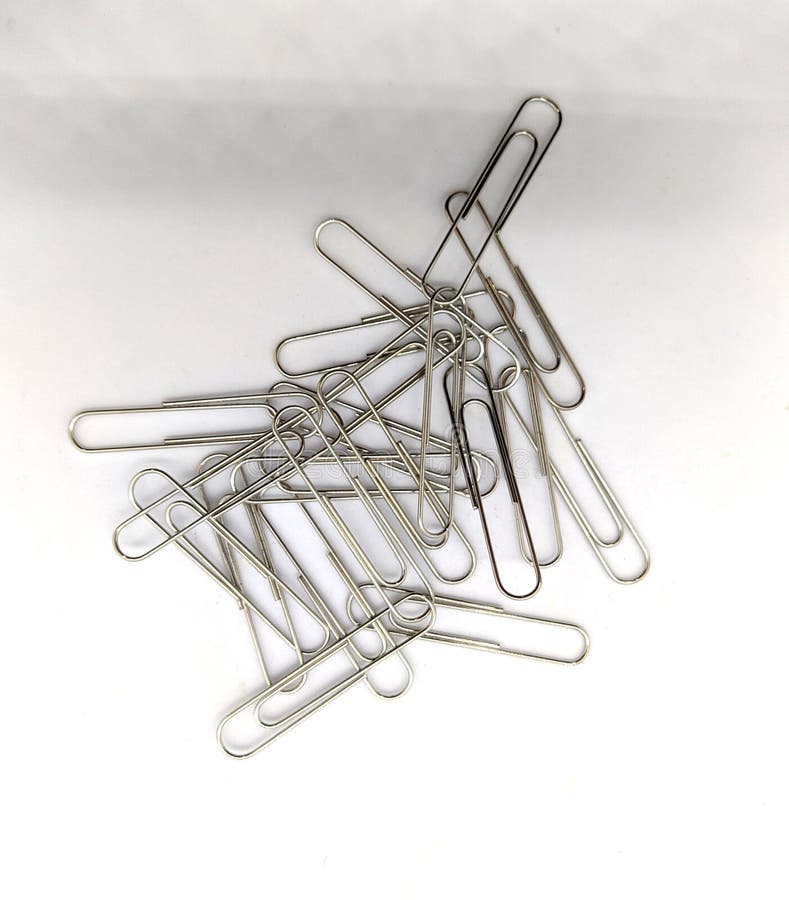 Metal Paper Clips. Metal Paper Clips on White Background Top View Stock ...