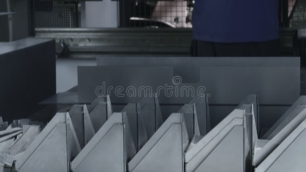 Metal Parts on Factory Table with Working Assembler. Creative Stock ...