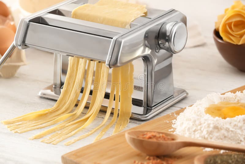 Metal Pasta Maker with Dough on Kitchen Table Stock Image - Image of ...
