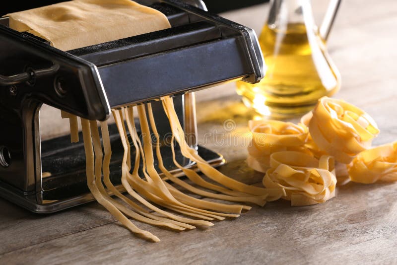 Metal Pasta Maker with Dough on Kitchen Table Stock Image - Image of ...