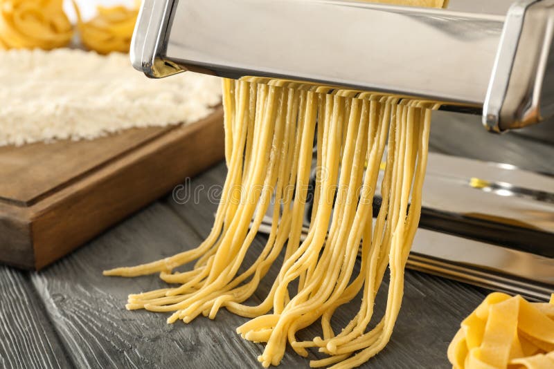 Metal Pasta Maker with Dough on Kitchen Table Stock Image - Image of ...