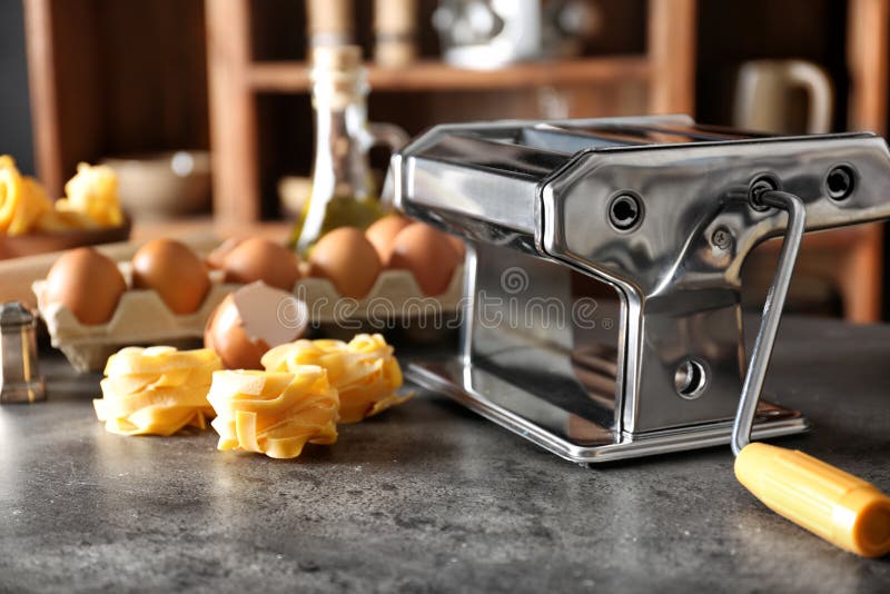 Metal Pasta Maker and Products on Kitchen Table Stock Photo - Image of ...