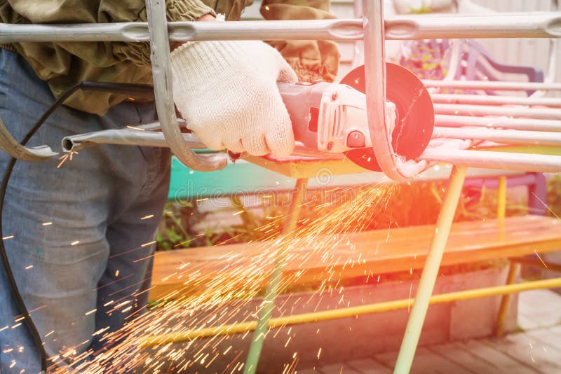 The Metal Pipe is Cut Out by a Chain Saw by the Hand of the Master ...