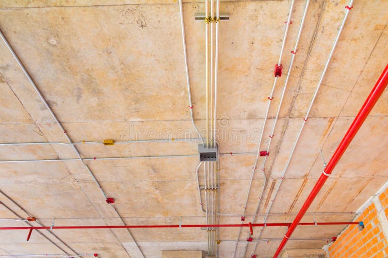 Metal Pipes in Construction and Fire Sprinkler on Red Pipe are Hanging ...