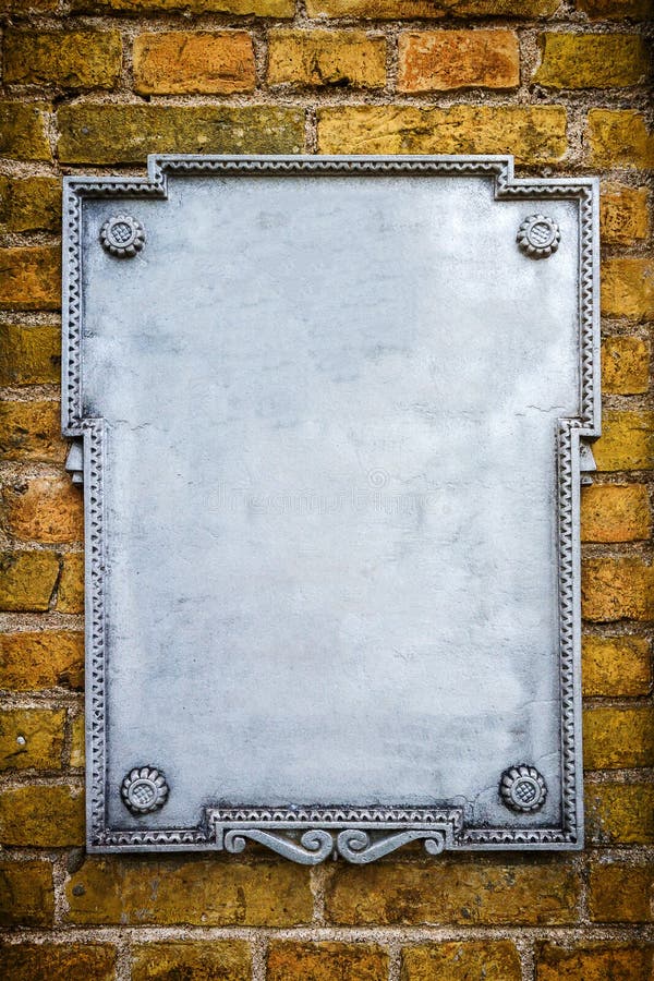 Metal plate on brick wall stock image. Image of plate - 50334843
