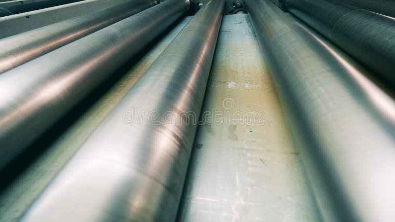 Metal Plate on the Conveyor and Spinning Rollers Moving it Stock Video ...
