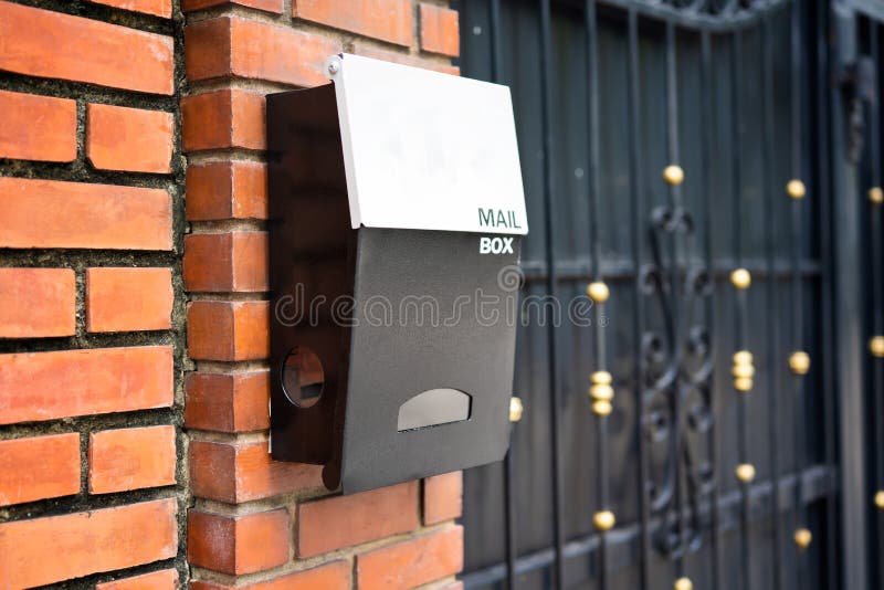 Metal Post Box on Brick Wall and White Address Plaque, Selective Focus ...