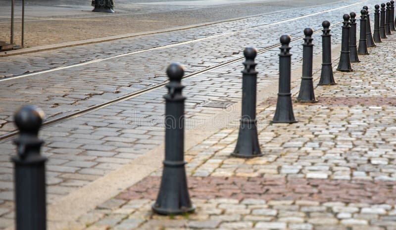 Black Posts Separating Paved Street and Path Stock Photo - Image of ...
