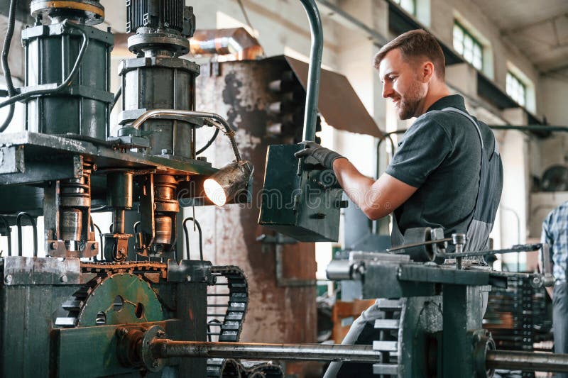 Metal Processing Device. Man in Uniform is in Workstation Developing ...