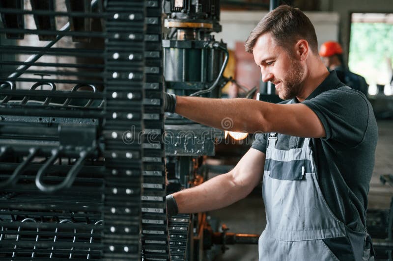 Metal Processing Device. Man in Uniform is in Workstation Developing ...