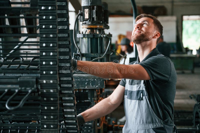 Metal Processing Device. Man in Uniform is in Workstation Developing ...
