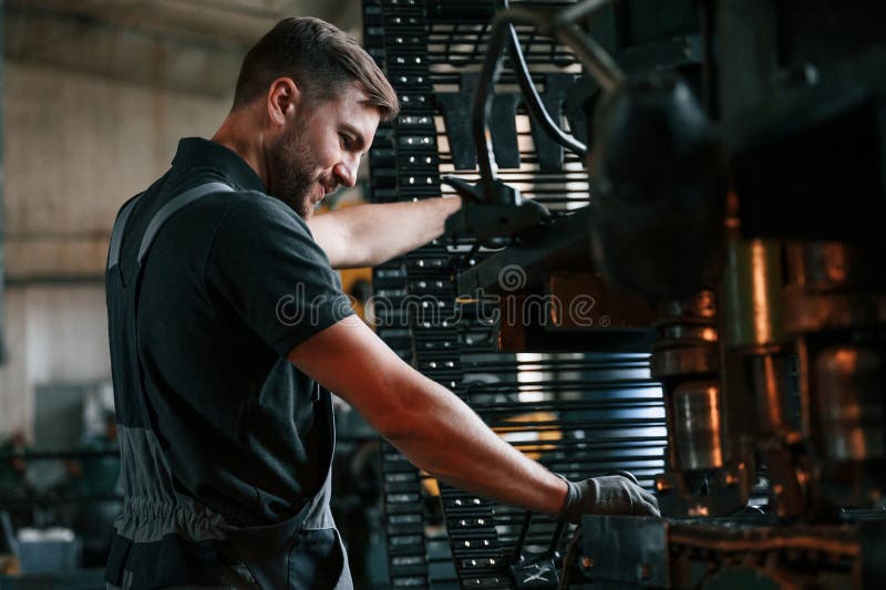 Metal Processing Device. Man in Uniform is in Workstation Developing ...