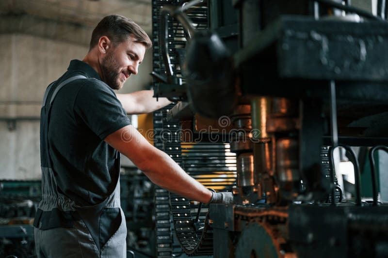 Metal Processing Device. Man in Uniform is in Workstation Developing ...