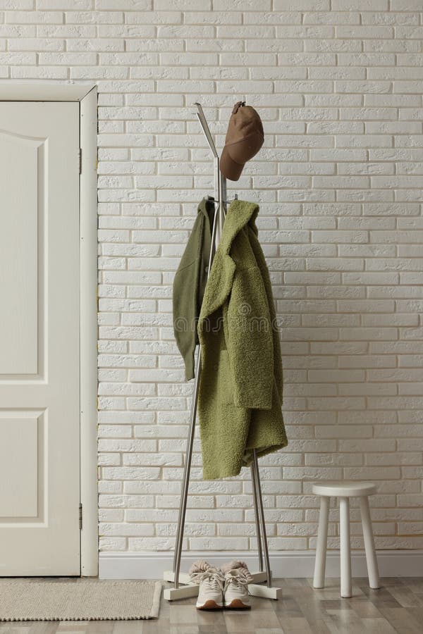 Metal Rack with Green Coat and Cap in Hallway Stock Image - Image of ...