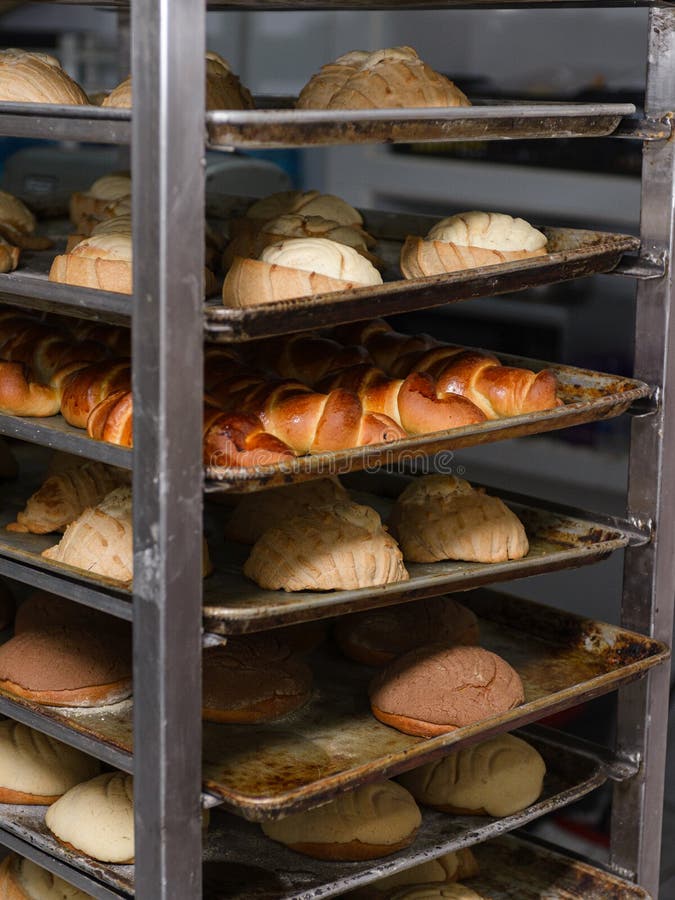 A Metal Rack Overflows with Various Freshly Baked Breads Stock Photo ...
