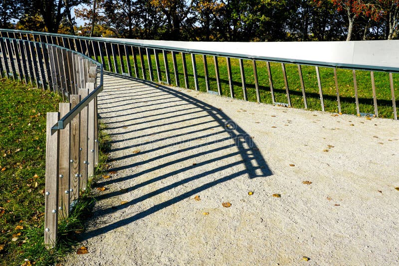 Metal Railing Casting Long Symmetrical Shadow Lines on the Surface of a ...