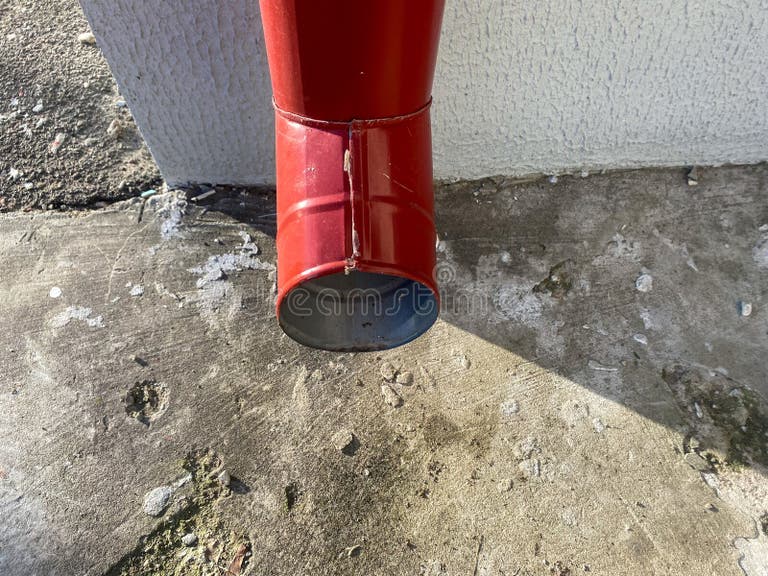 A Metal Red Drain Pipe Hanging from the Building Stock Image - Image of ...